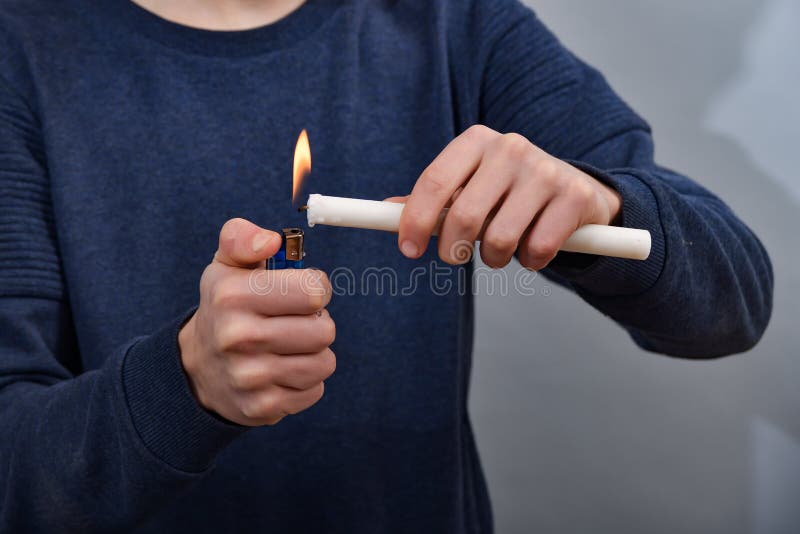 A Man Lights a Candle with a Lighter Stock Image - Image of brown ...