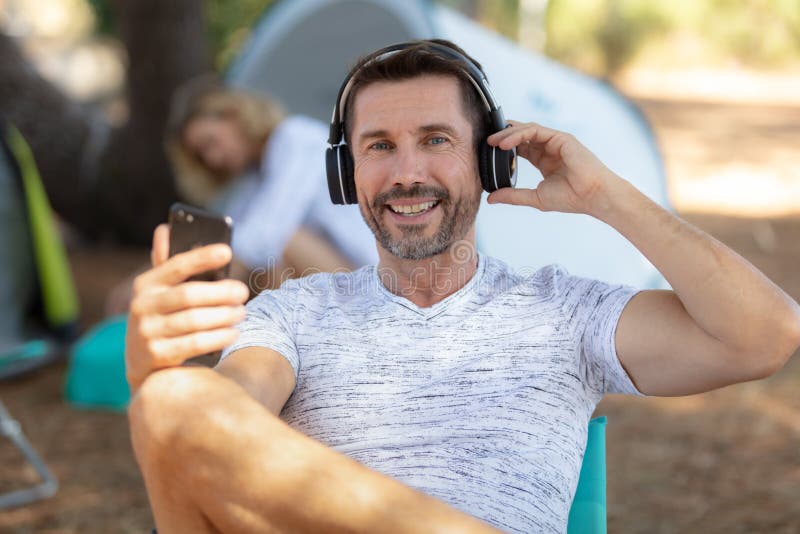 Man Listening To Mp3 Player in Tent Stock Image - Image of activity ...