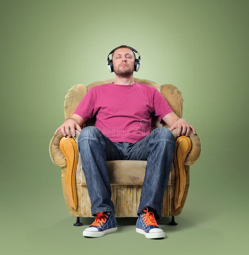 Man Listening To Relaxing Music While Sitting In A Chair Stock Image