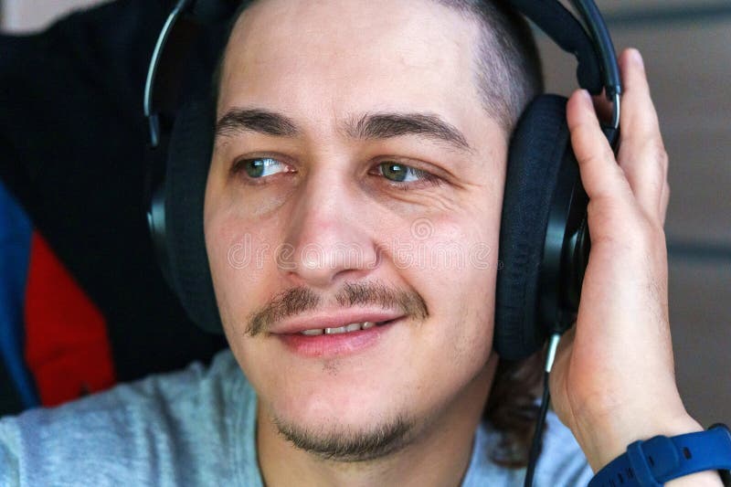 A Man Listens To Music with Deep Concentration, Showcasing a Thoughtful ...