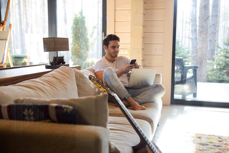 Man in living room stock photo. Image of cheerful, phone - 91851022