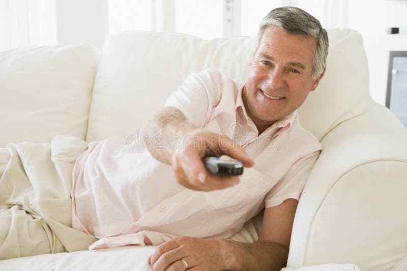 Man in Living Room Using Remote Control Smiling Stock Photo - Image of ...
