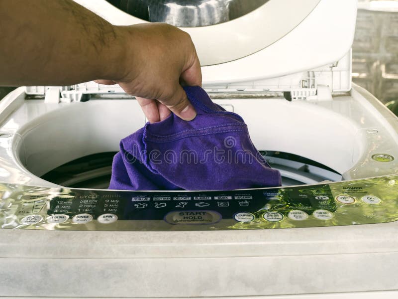 A Man Load Dirty Clothes in the Washing Machine Stock Image - Image of ...