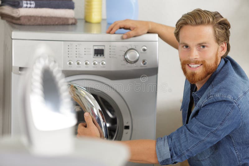 Man Loading Clothes or Fabric into Washing Machine Stock Photo - Image ...