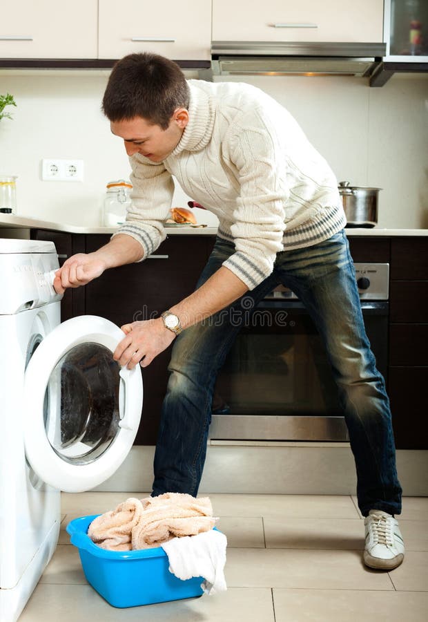 Man Loading Clothes into the Washing Machine Stock Photo - Image of ...