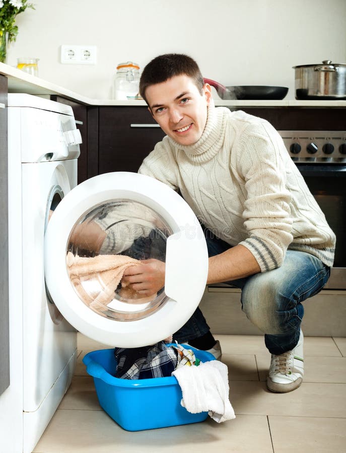 Man Loading Clothes into the Washing Machine Stock Image - Image of ...