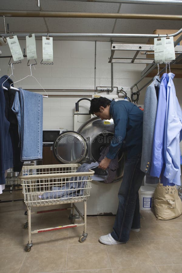Man Loading Clothes in Washing Machine at Laundry Stock Image - Image ...