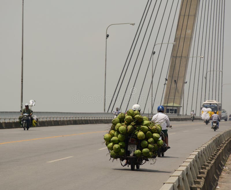 A Man Loading Coconut on Binh Bridge Editorial Photo - Image of black ...