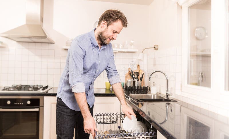 Man Loading Dishwasher Machine in the Home Kitchen Stock Image - Image ...