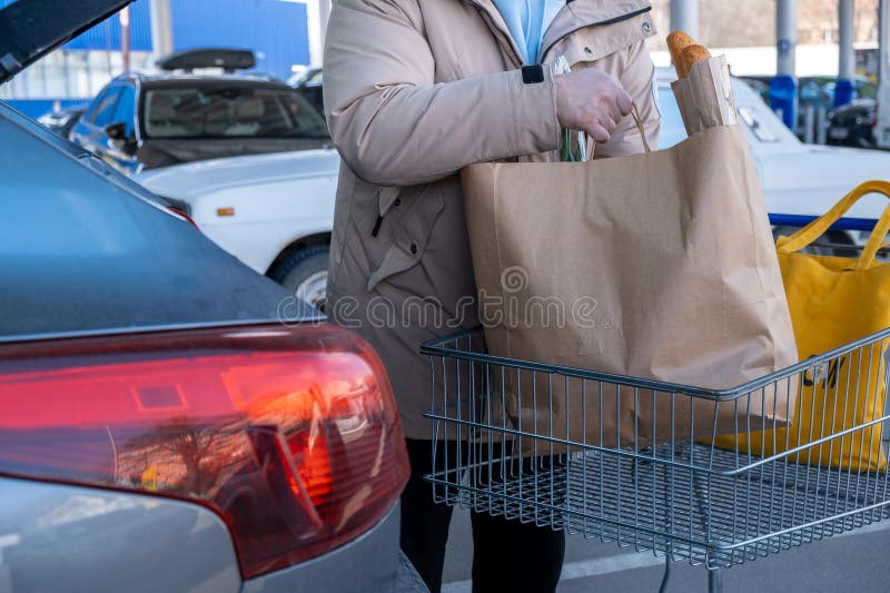 Man Loading Groceries into Car Trunk Stock Image - Image of market ...