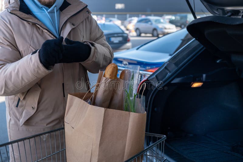 Man Loading Groceries into Car Trunk Stock Photo - Image of supermarket ...