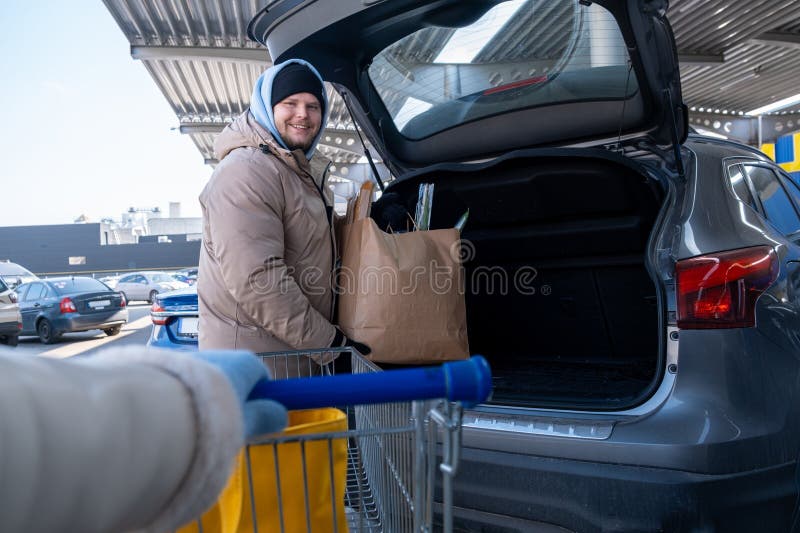 Man Loading Groceries into Car Trunk Stock Photo - Image of cart, buyer ...