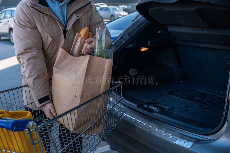 Man Loading Groceries into Car Trunk Stock Photo - Image of outdoor ...