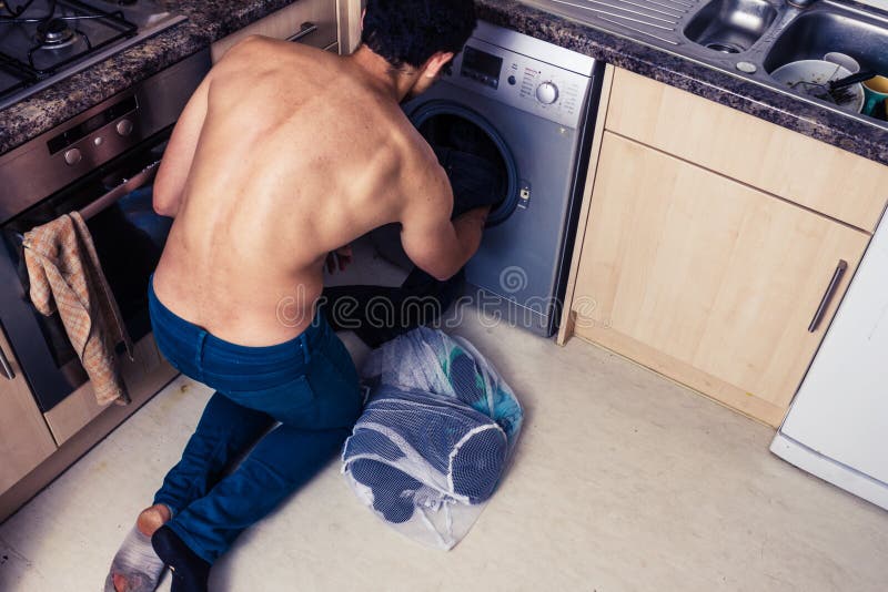 Man Loading His Washing Machine Stock Image - Image of racial, person ...