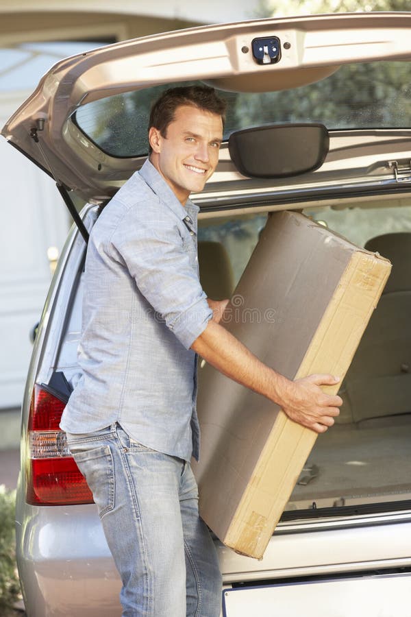 Man Loading Large Package into Back of Car Stock Photo - Image of ...