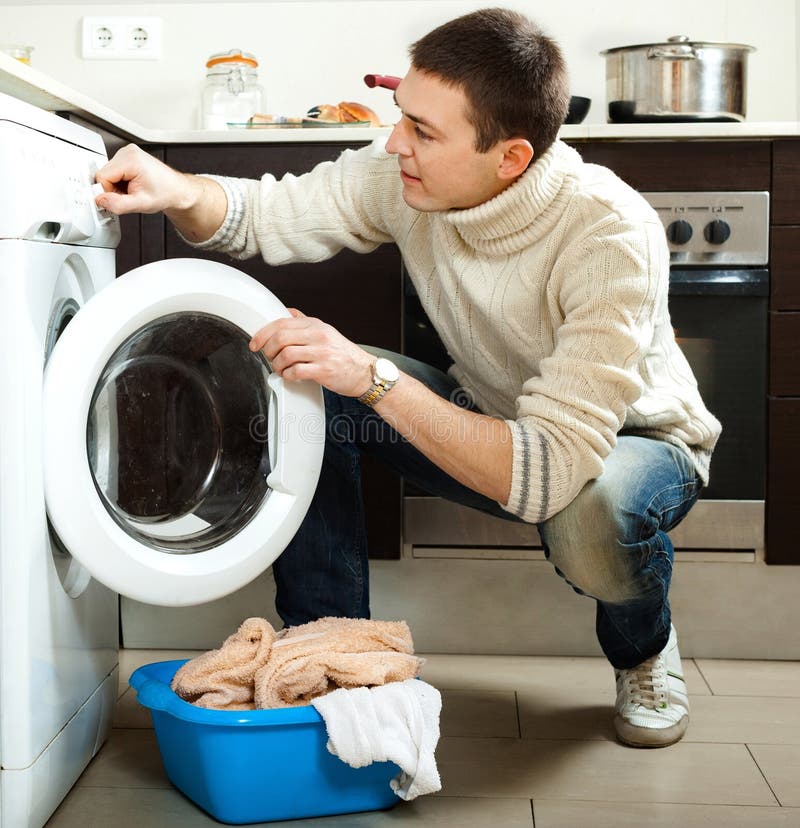 Man Loading the Washing Machine Stock Photo - Image of machine, adult ...