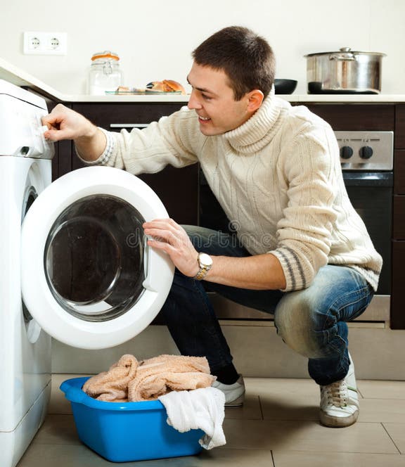 Man Loading the Washing Machine Stock Photo - Image of machine, adult ...