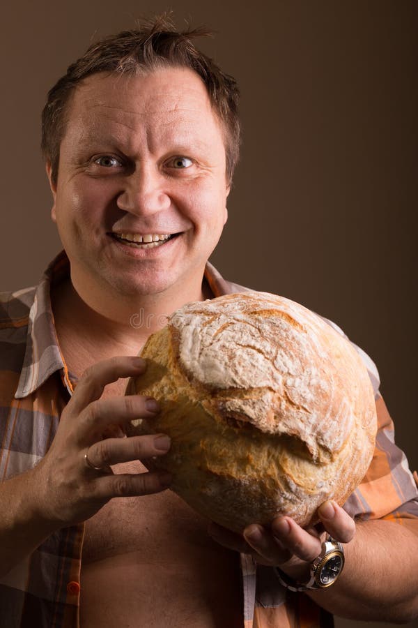 Man and loaf of bread 3 stock image. Image of pastry - 133821903