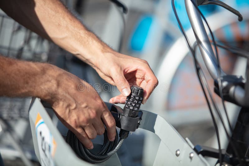 Man Locking Bicycle with Metal Chain Outside Stock Image - Image of ...