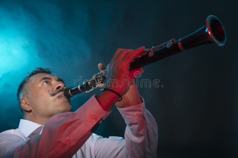 A Man with a Long, Imposing Mustache Plays the Clarinet. Studio, Dark ...