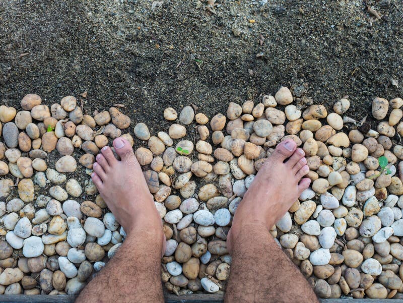 A Man Look Down To His Feet, Stand on the Rocks. Stock Photo - Image of ...