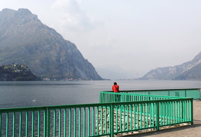 Man looking above lake. stock image. Image of italy, alps - 19629085