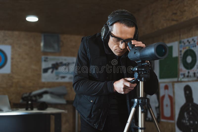 Man Looking through Binoculars at Remote Target Stock Photo - Image of ...