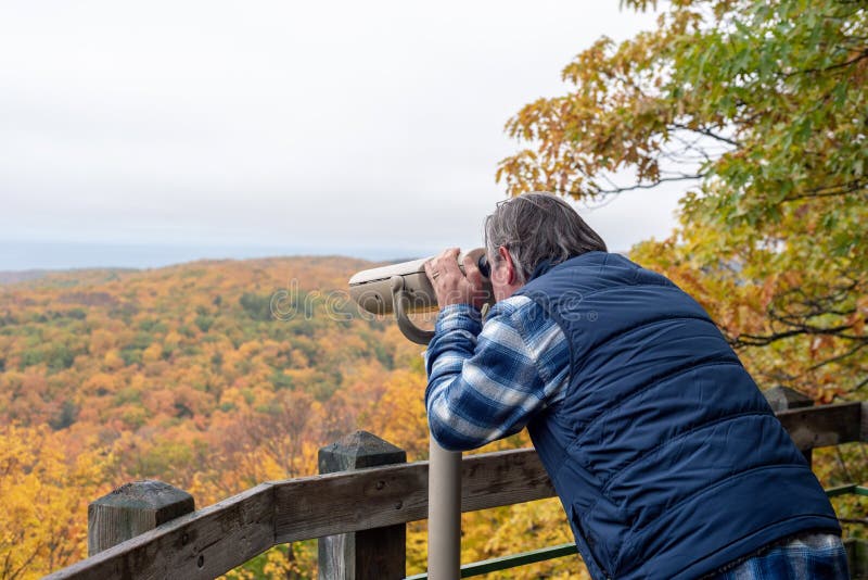 Man Looking through Binoculars at Scenic Overlook Stock Photo - Image ...