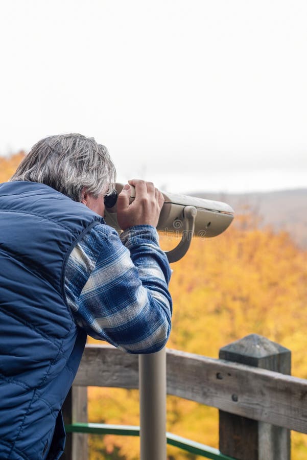 Man Looking through Binoculars at Scenic Overlook Vertical Stock Image ...