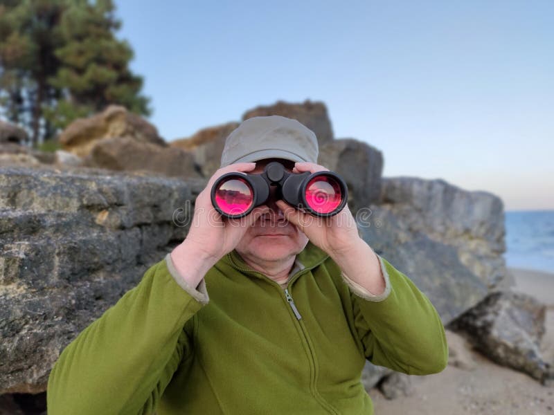 A Man Looking through Binoculars on the Seashore Stock Photo - Image of ...
