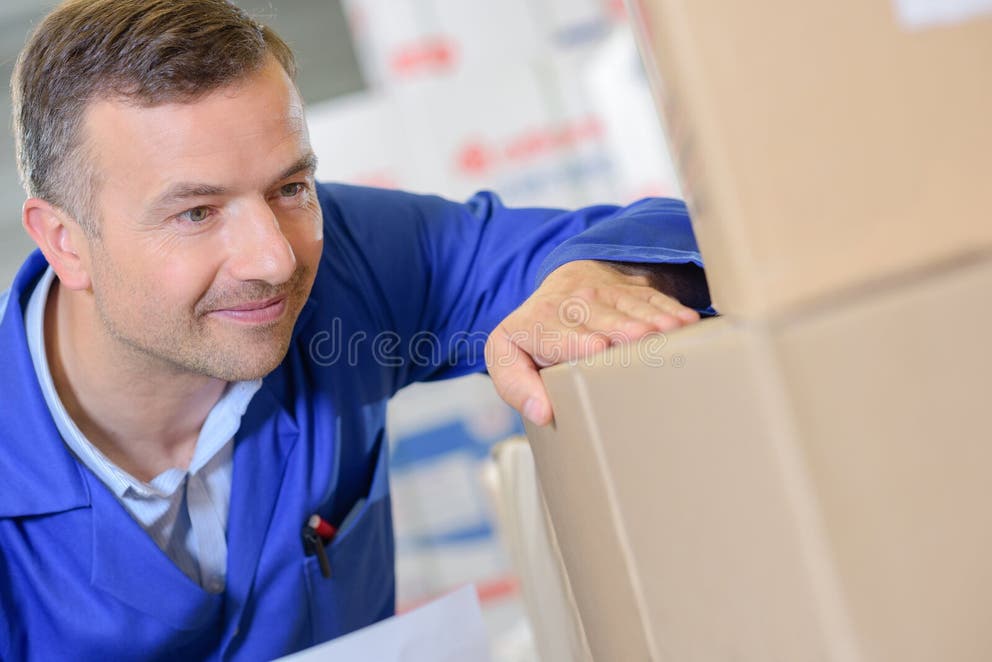 Man looking at boxes stock photo. Image of warehouse - 298846366