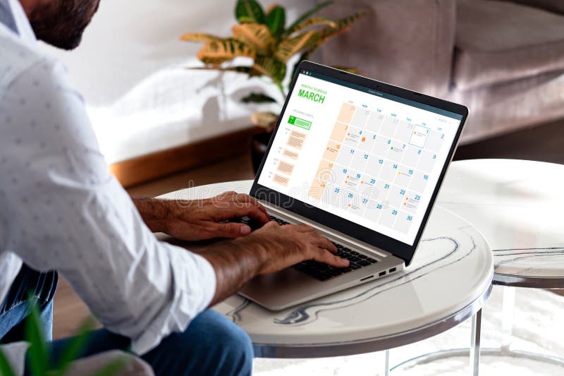 Man Looking at Calendar on Laptop, Early in the Morning To Plan the Day ...