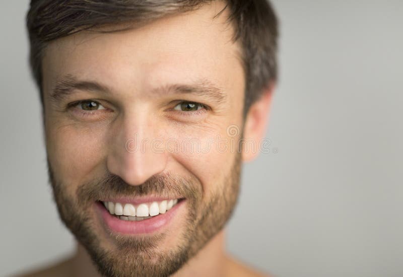 Man Looking at Camera Smiling Posing Over Gray Background Stock Photo ...