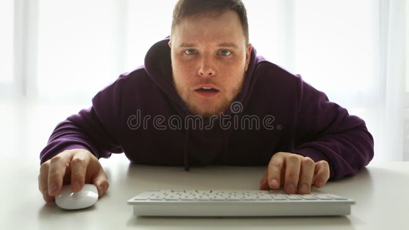 Man Looking at Camera Typing on Keyboard Looking for Information Stock ...