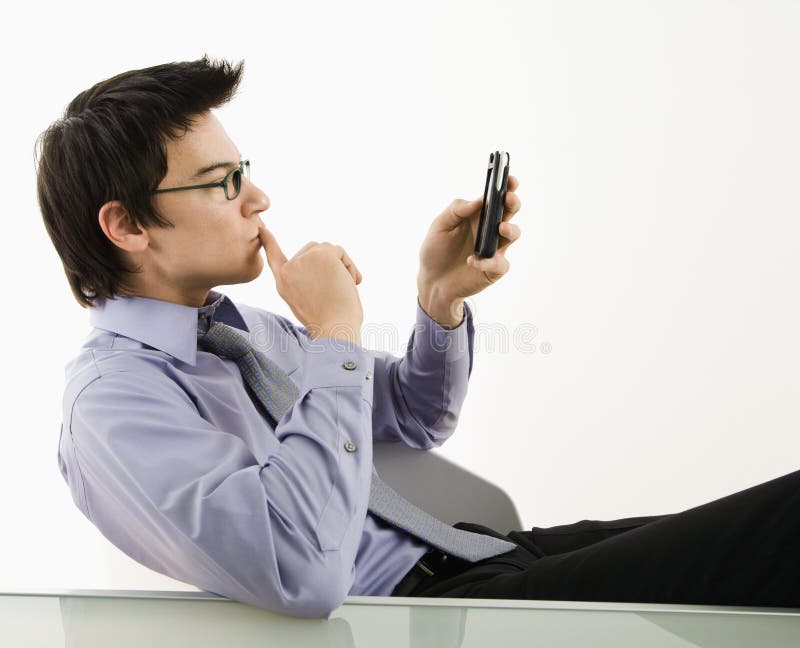 Man looking at cell phone. stock photo. Image of asian - 6153134