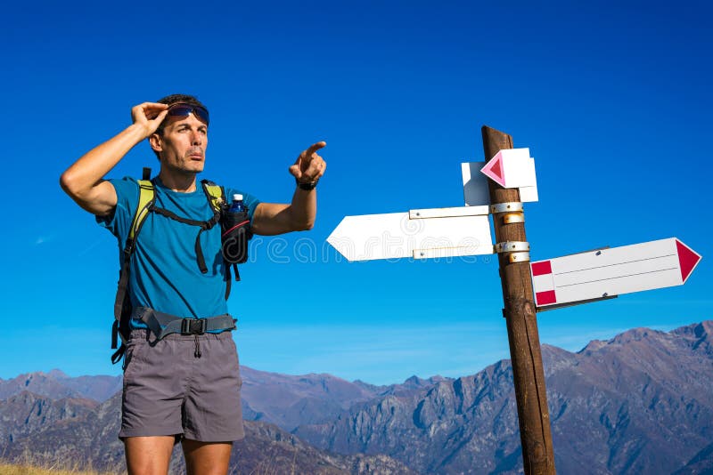 Man Looking for Direction at Crossroad Stock Photo - Image of looking ...