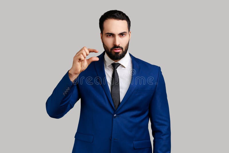 Man Looking Disappointed and Showing a Little Bit Gesture, Small Amount ... Man Looking Disappointed and Showing a Little Bit Gesture, Small Amount ...