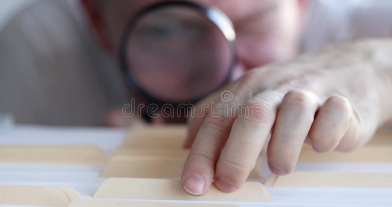 Man Looking for Document in Folders Using Magnifying Glass 4k Movie ...