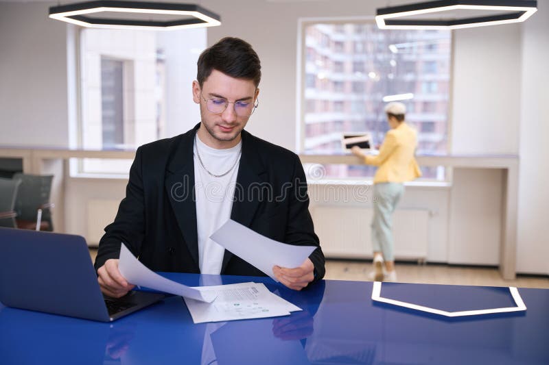 Man Looking through Documents at Coworking Space Stock Photo - Image of ...