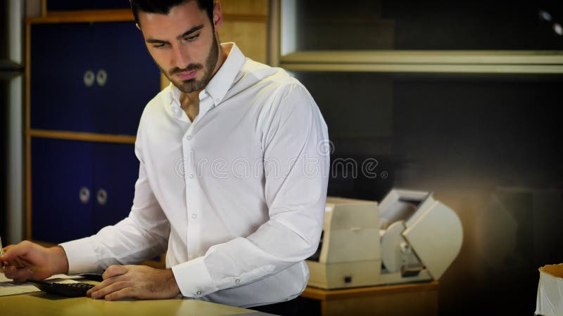 Man Looking at Documents at Office Counter Stock Image - Image of ...