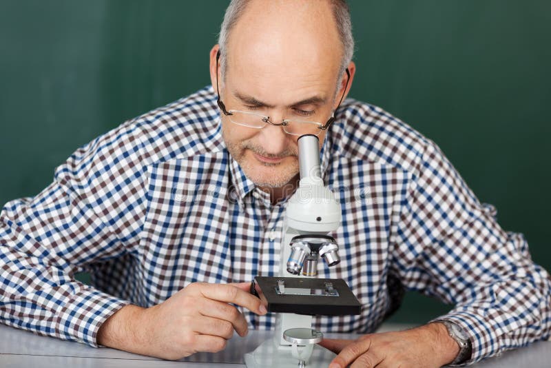Man Looking Down a Microscope Stock Photo - Image of monocular ...