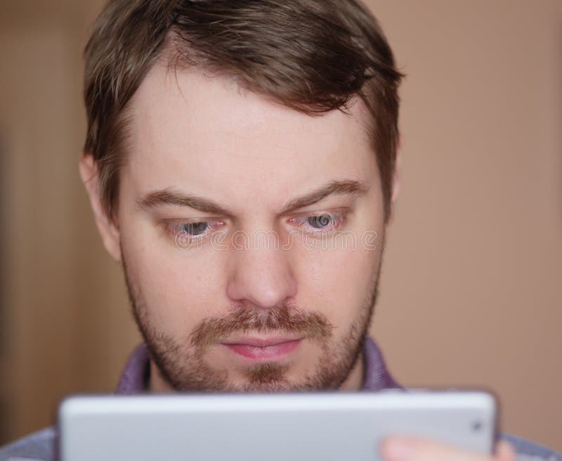 Man Looking Down at Pda on Beige Background Stock Photo - Image of ...