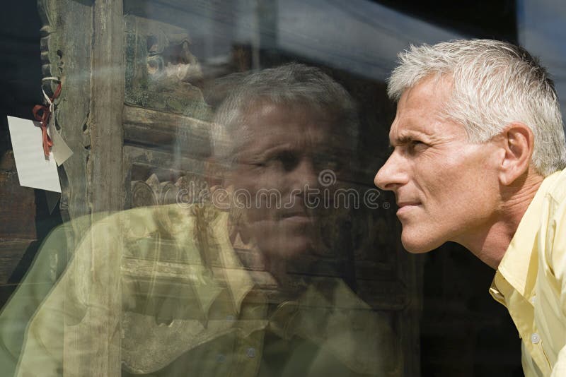 Man Looking at Dresser in Shop Window Stock Photo - Image of photograph ...
