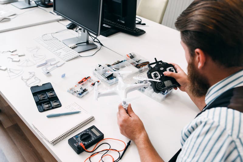 Man Looking at Drone and Remote Control Stock Photo - Image of master ...