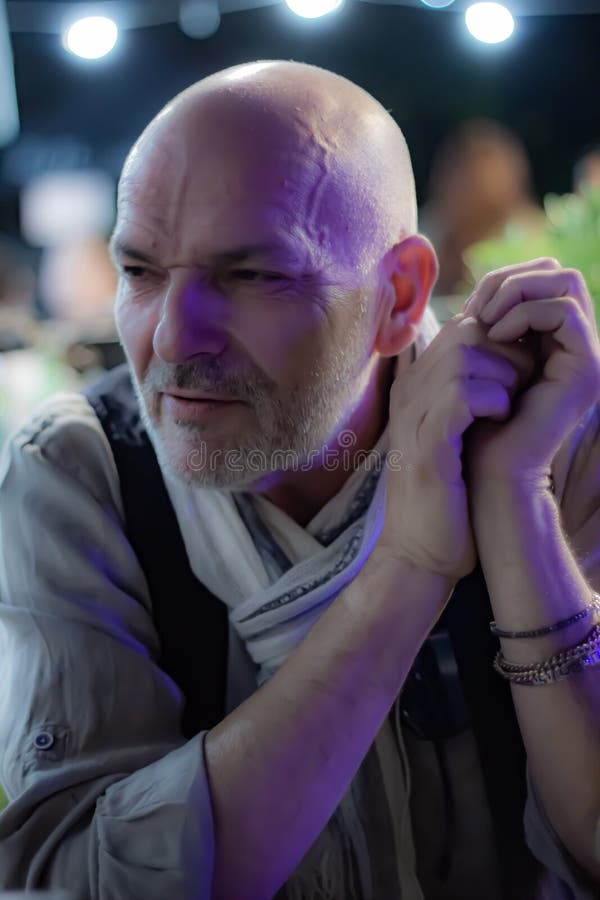 Man Looking with Elbows Leaning on the Table with a Slight Smile Stock ...