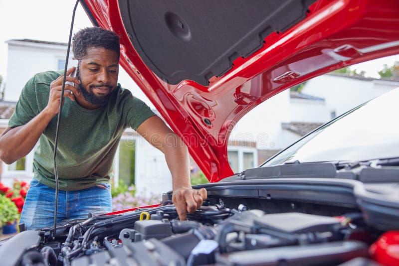 Man Looking at Engine after Car Breakdown Calling Auto Recovery on ...