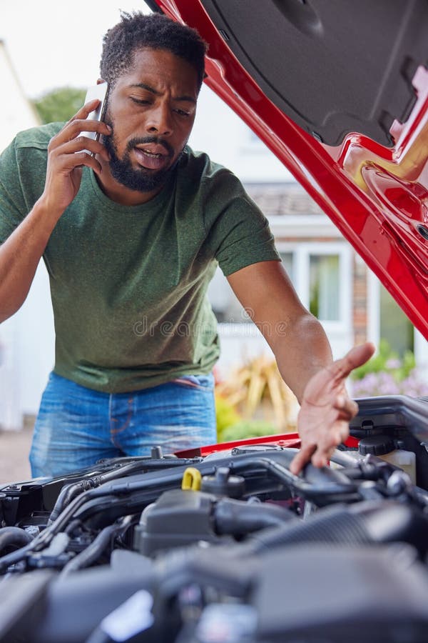 Man Looking at Engine after Car Breakdown Calling Auto Recovery on ...
