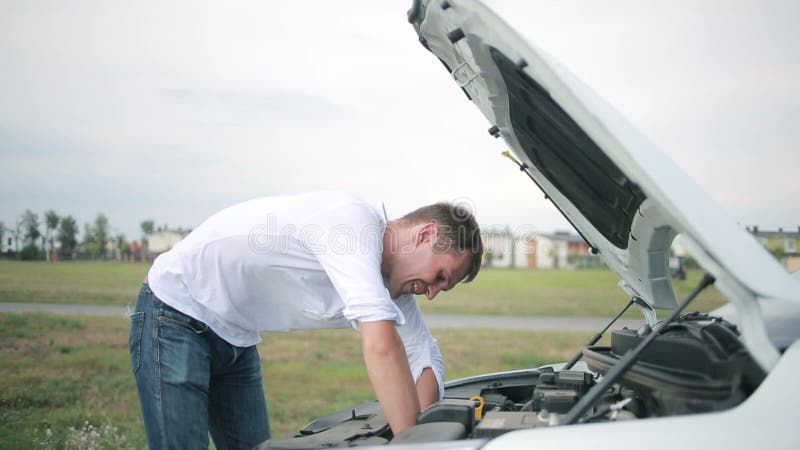 Man Looking at Engine of Car. Man Repairing Broken Car Stock Video ...