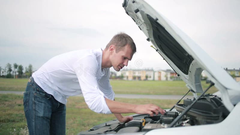 Man Looking at Engine of Car. Man Repairing Broken Car. Winter Driving ...