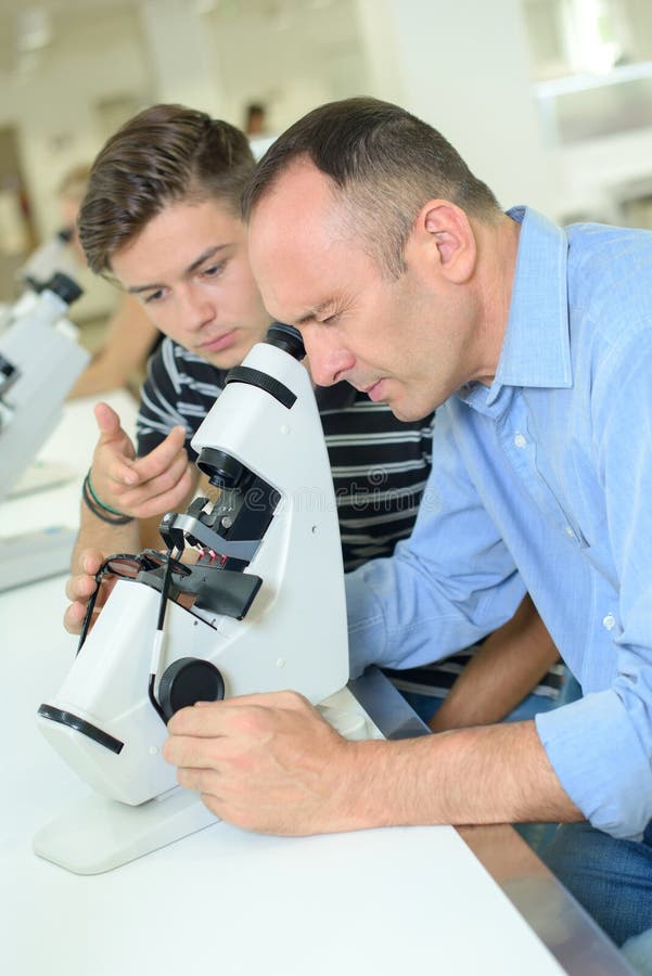 Man Looking into Eyepiece Microscope Stock Image - Image of caucasian ...